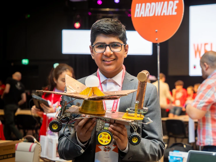 A young person showing their Coolest Projects entry